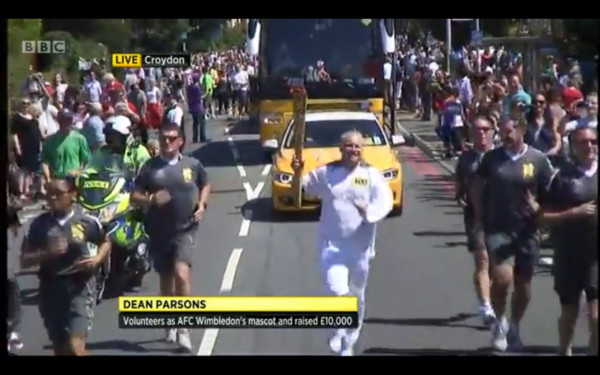 Dean Parsons (Haydon the Womble) carries the Olympic Flame – Tidy Bag